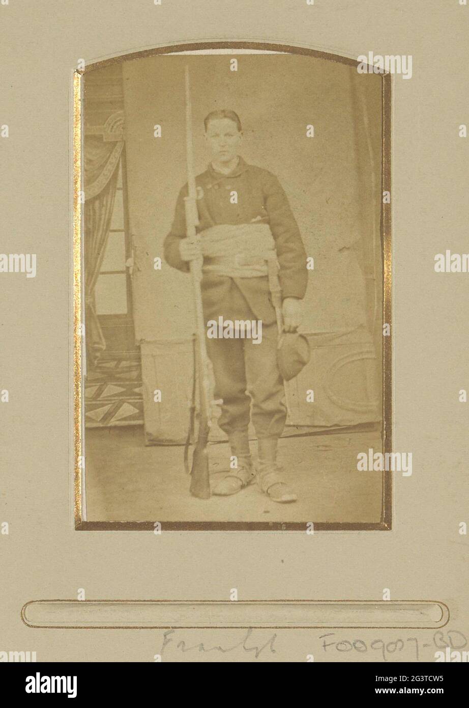 Portrait of a soldier with sash around the waist and rifle. Part of ...