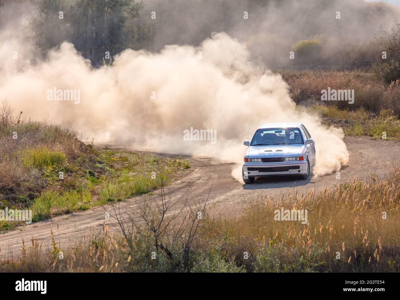 One Rally Car and a lot of Dust on a Sharp Turn Stock Photo - Alamy