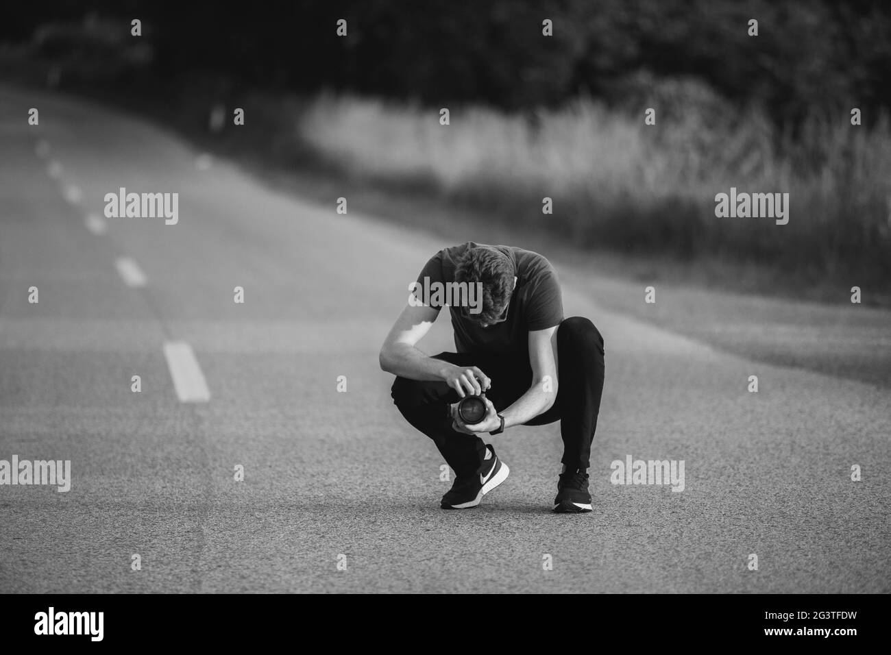 Man squatting down Black and White Stock Photos & Images - Alamy