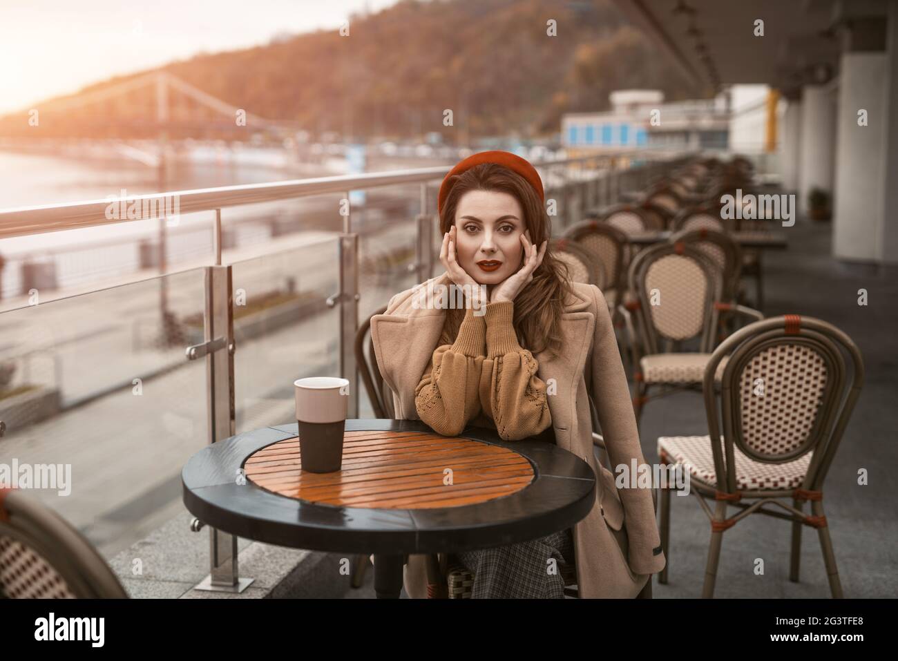 Disappointed or frustrated french young woman sitting outdoors ...