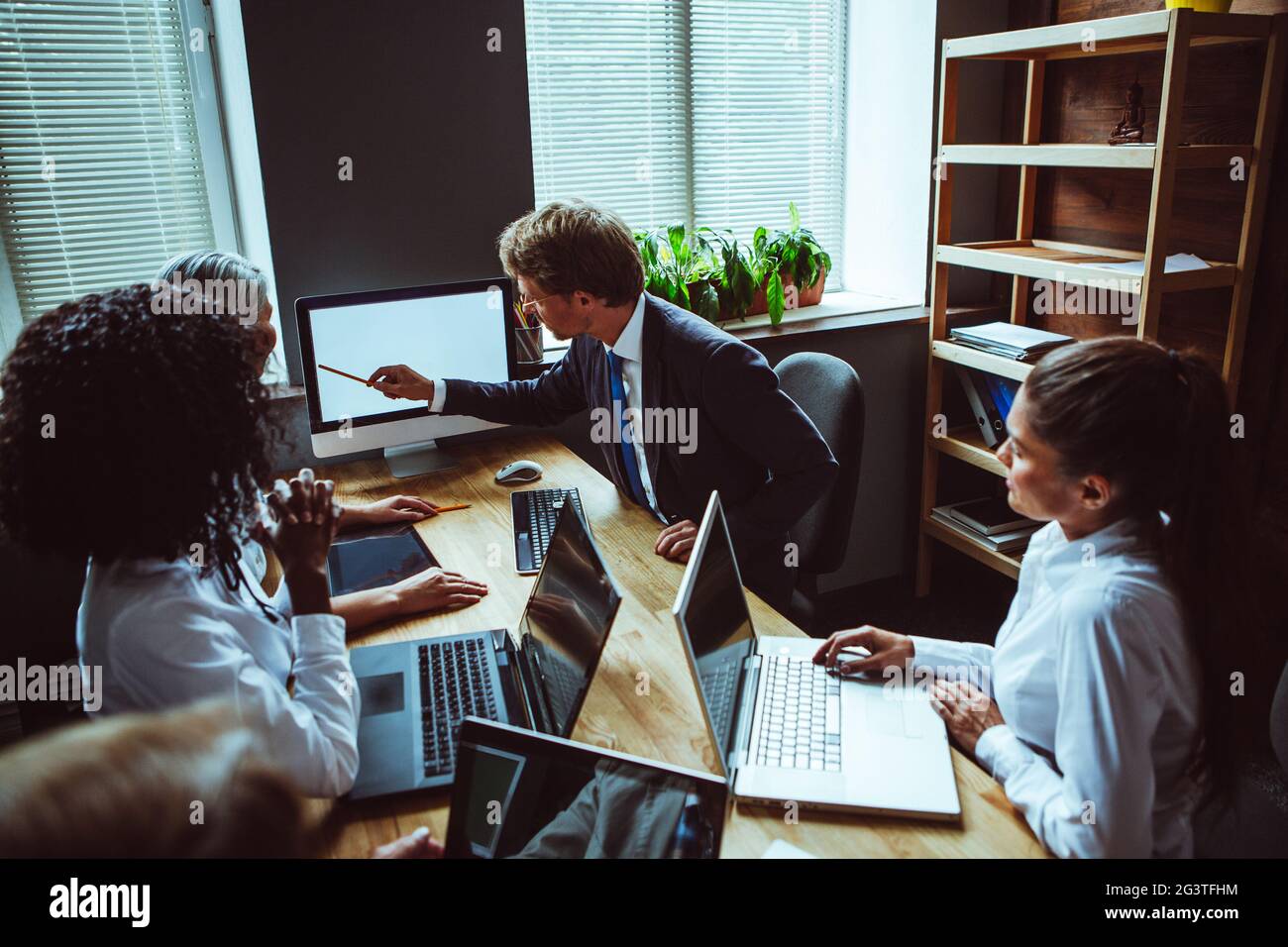Young group of multi ethnic business people looking at computer with ...