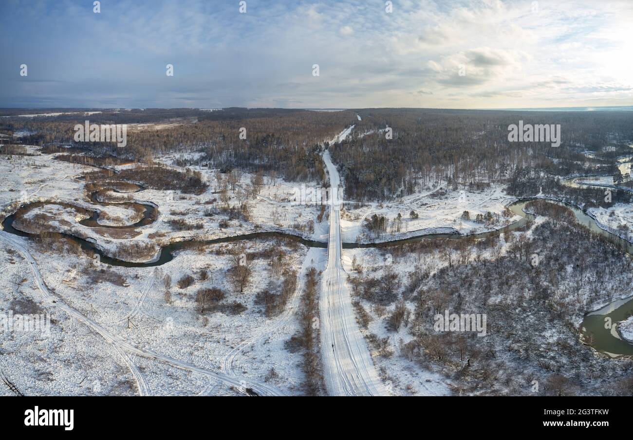 Aerial photo panorama of Koen river and road bridge under ice and snow ...