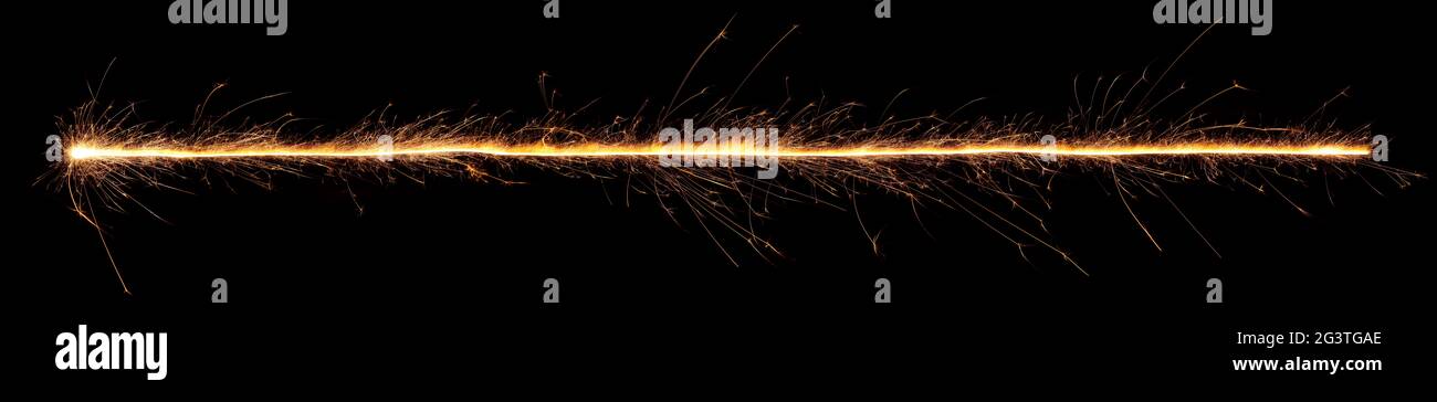 Sparkler trail of light with sparks in a straight line Stock Photo - Alamy