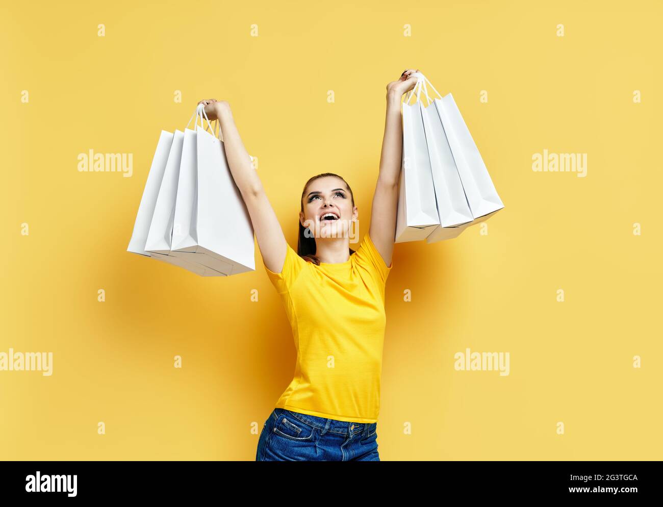 Happy excited shopaholic woman with shopping bags in hands enjoy her ...