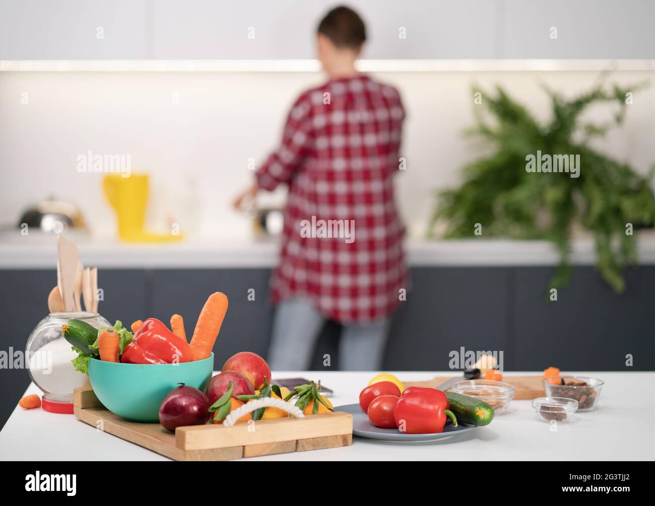 Mother cooking dinner for a loving family washing ingredients standing ...