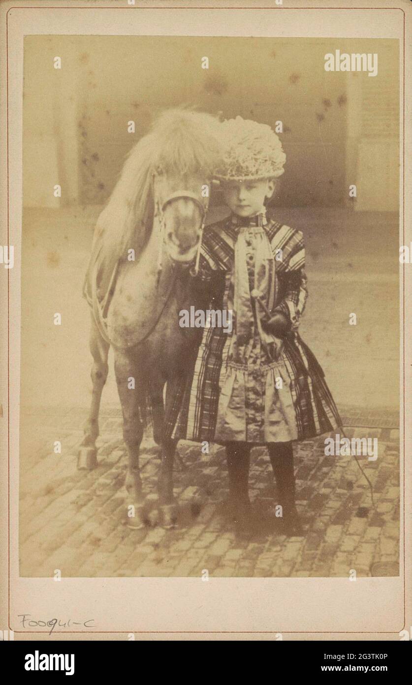 Portrait of Princess Wilhelmina as a young girl, standing next to a ...