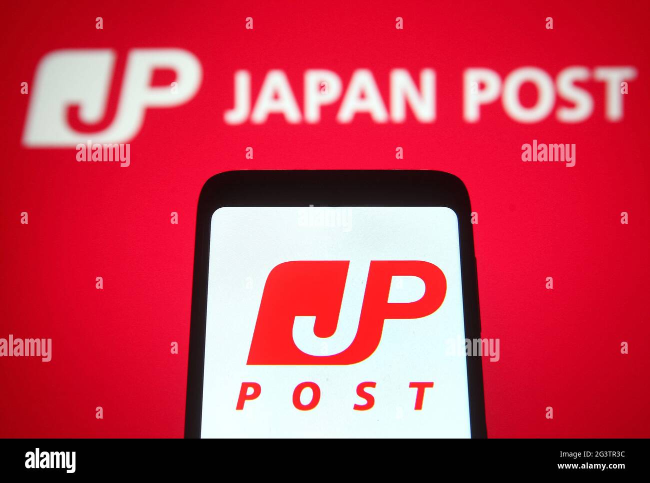 In this photo illustration, Japan Post Holdings logo is seen on a ...