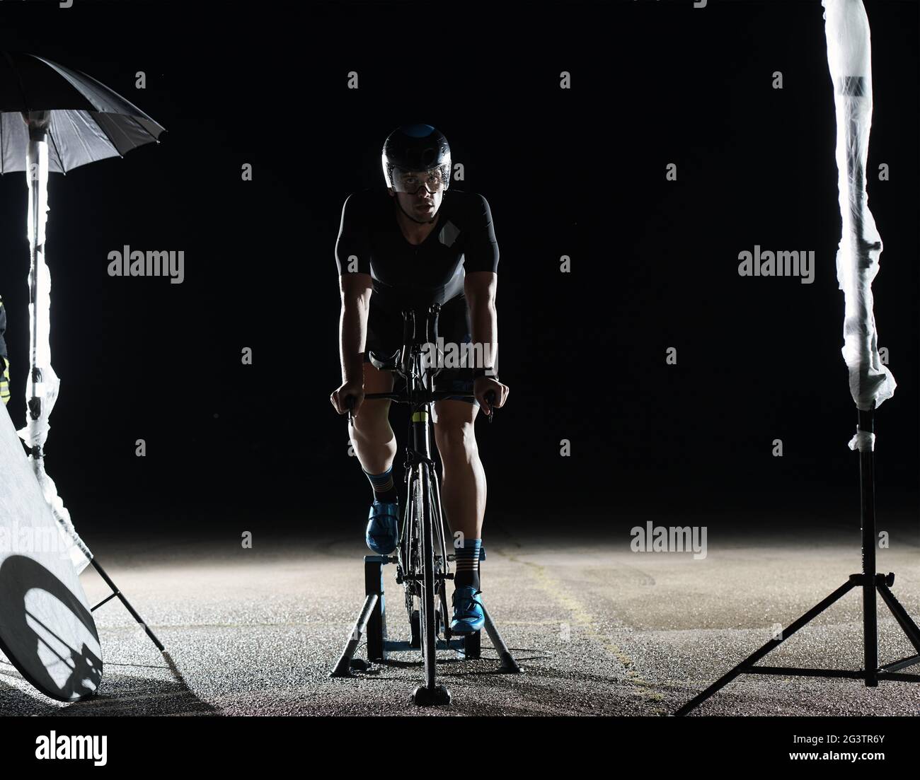 Triathlon athlete portrait while resting on bike training Stock Photo ...