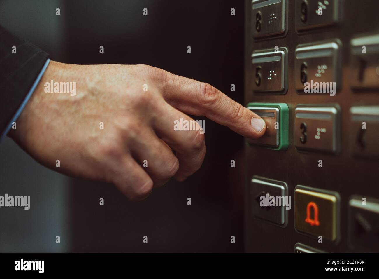 Close up of male hand presses button with braille for blind. Close up ...