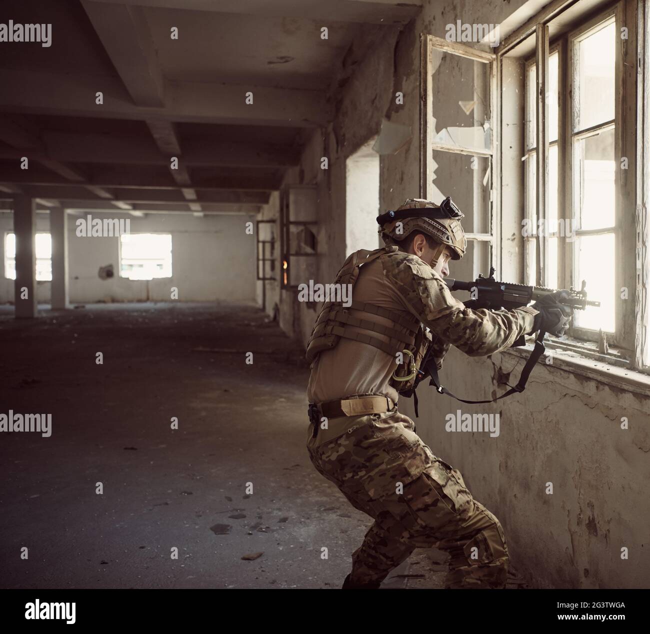 Soldier in action near window changing magazine and take cover Stock ...