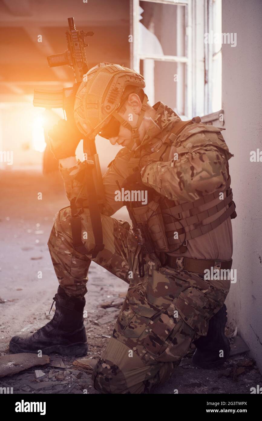 Soldier in action near window changing magazine and take cover Stock ...