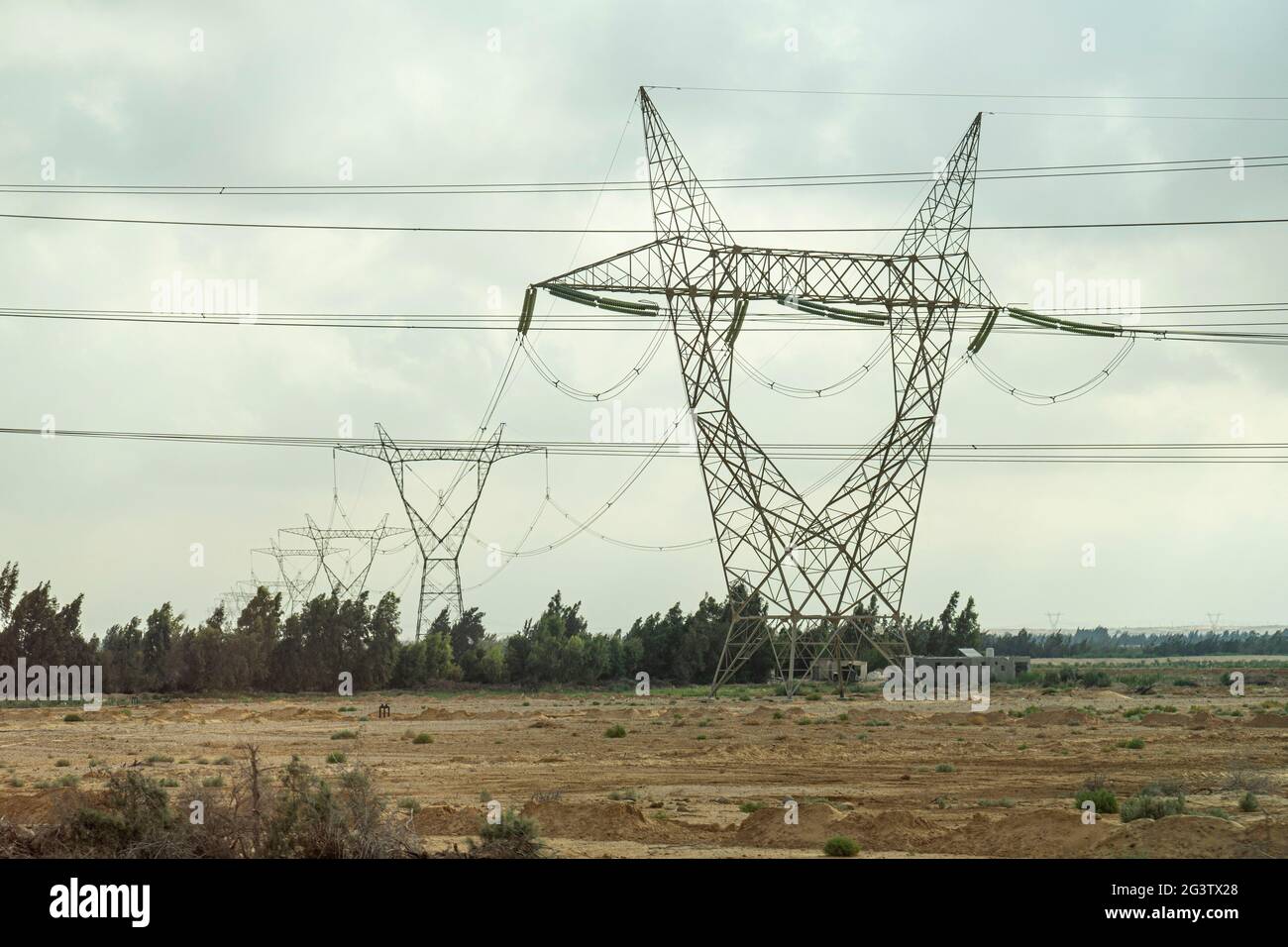 Power lines in the desert against a cloudy sky Stock Photo - Alamy