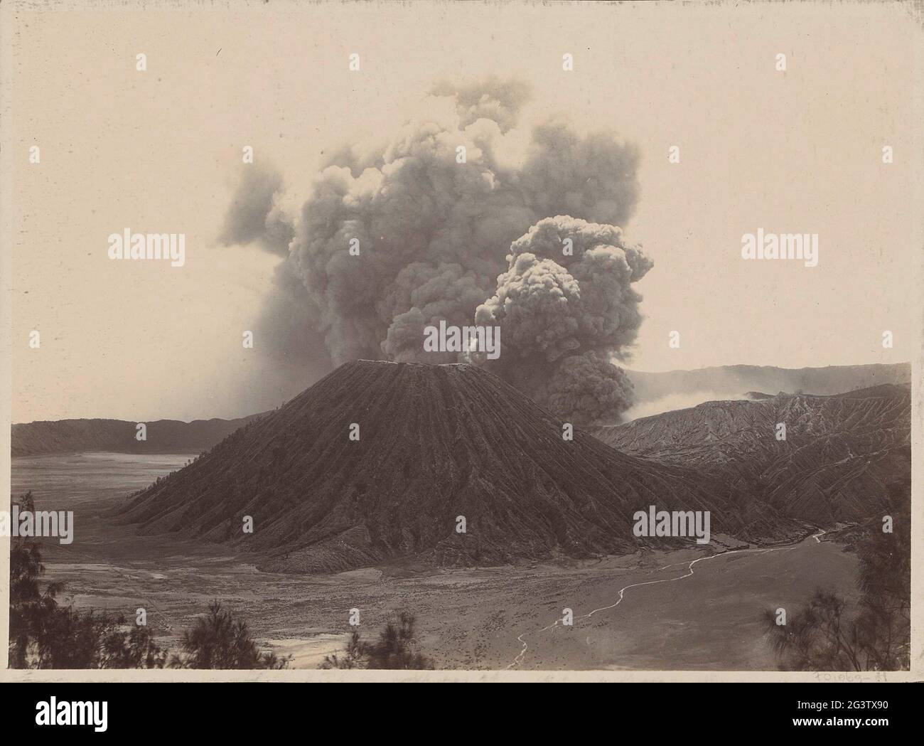 Smoking volcano in the Dutch East Indies. Part of travel album with ...