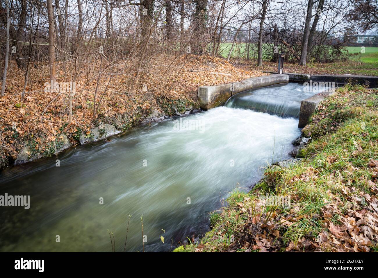 Canal with running water at a park Stock Photo - Alamy