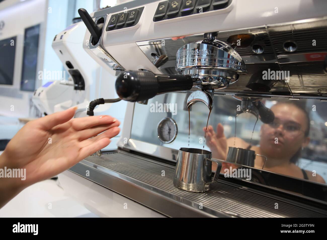 Minsk. Belarus - 06.06.2021: A cute barista makes coffee in a coffee ...