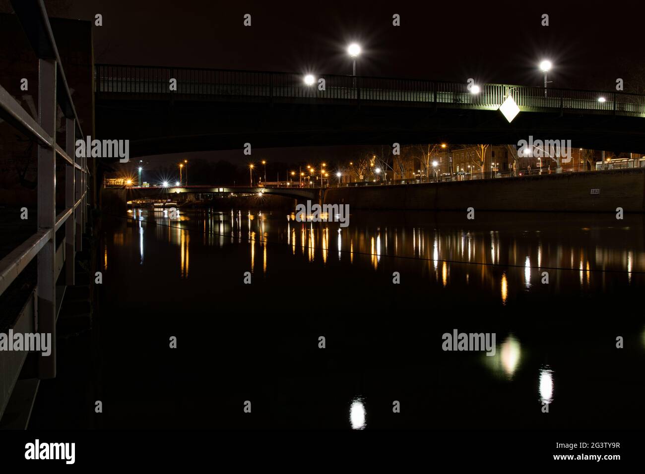 Reflection of lights on a canal in a city captured at night Stock Photo ...
