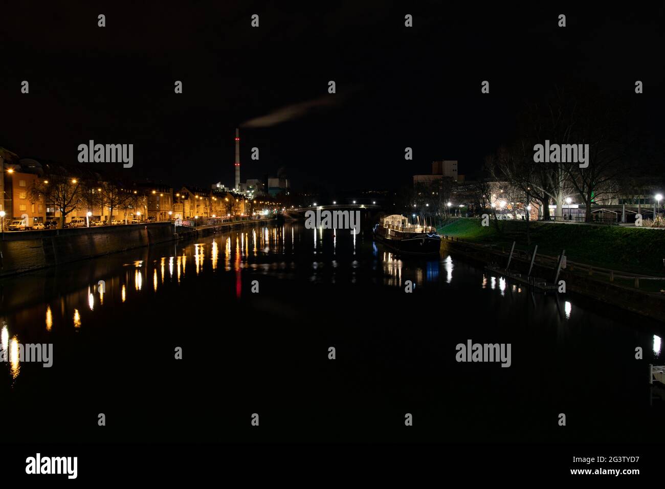 Reflection of lights on a canal in a city captured at night Stock Photo ...