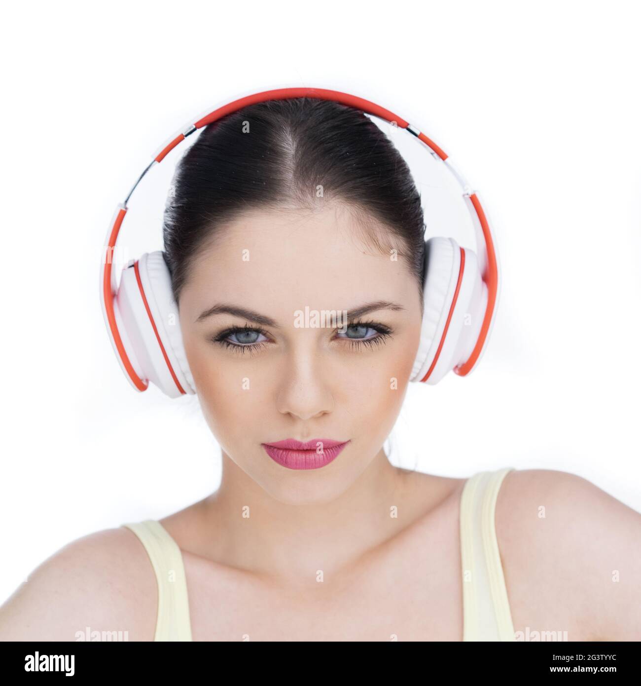 Closeup of a girl listening to music over white background Stock Photo ...