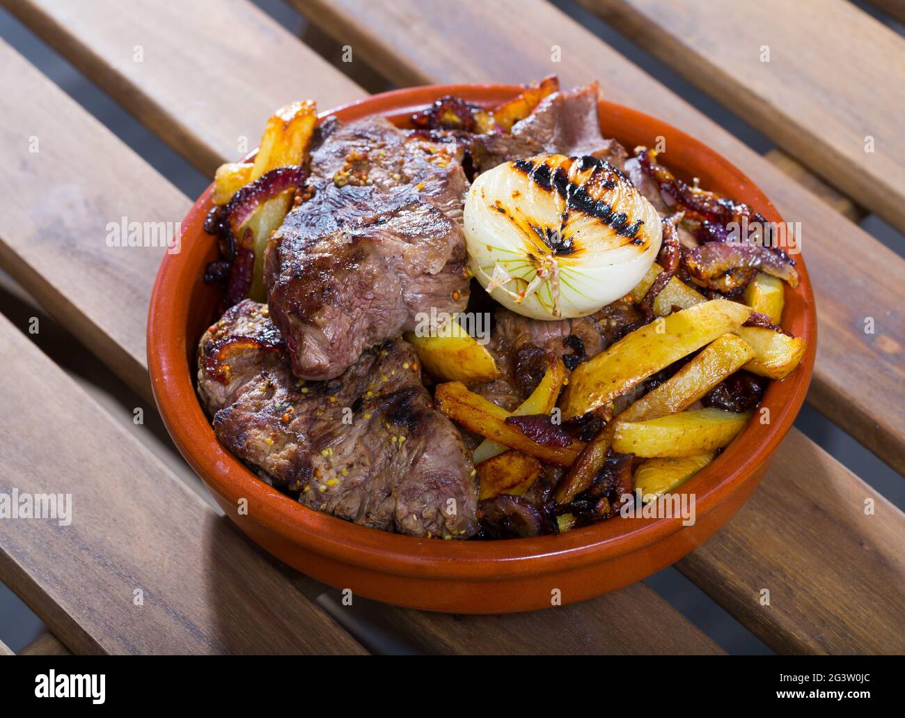 Cooked braised tenderloin of beef with potatoes and onions at clay pot ...