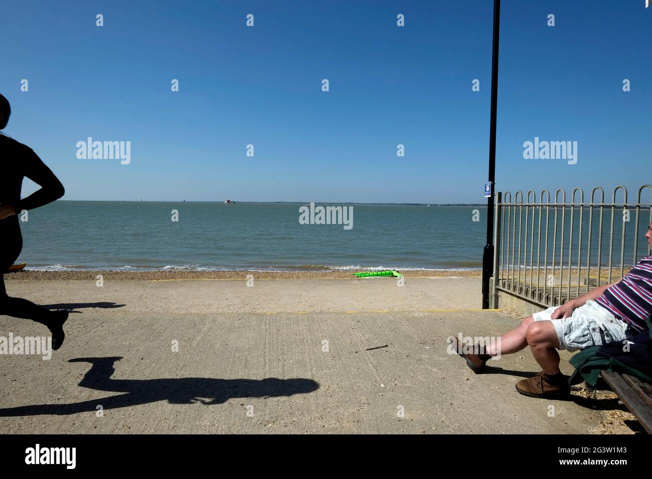 man running out of frame at seaside Stock Photo - Alamy