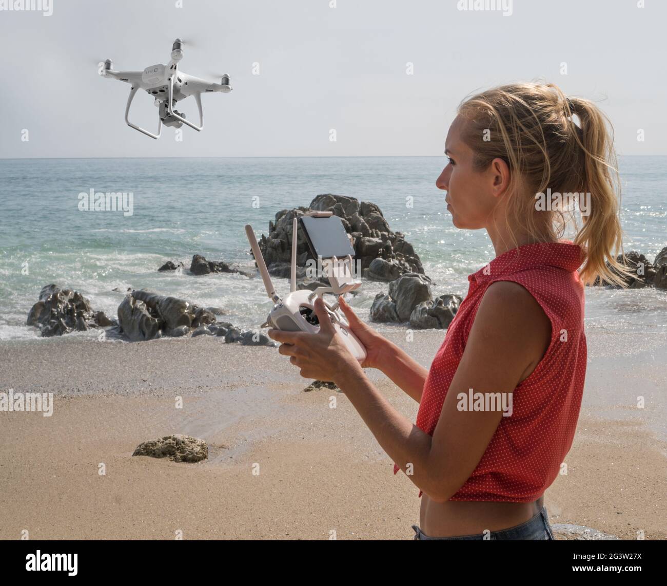 Pretty woman taking photos with drone camera Stock Photo - Alamy