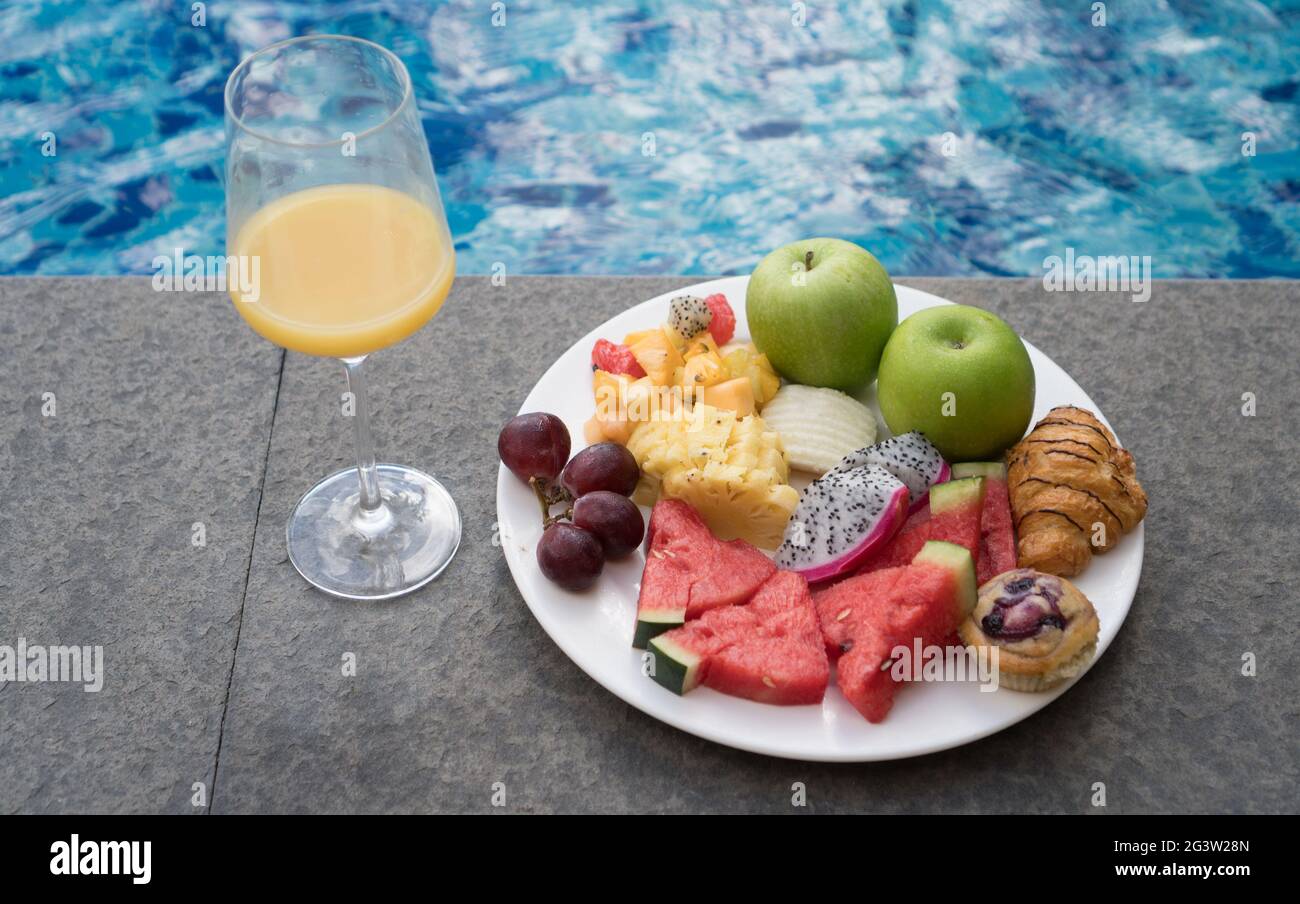 Fruit plate by hotel pool Stock Photo - Alamy