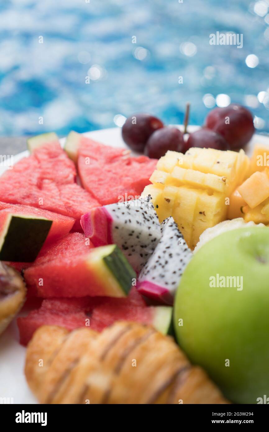 Fruit plate by hotel pool Stock Photo - Alamy