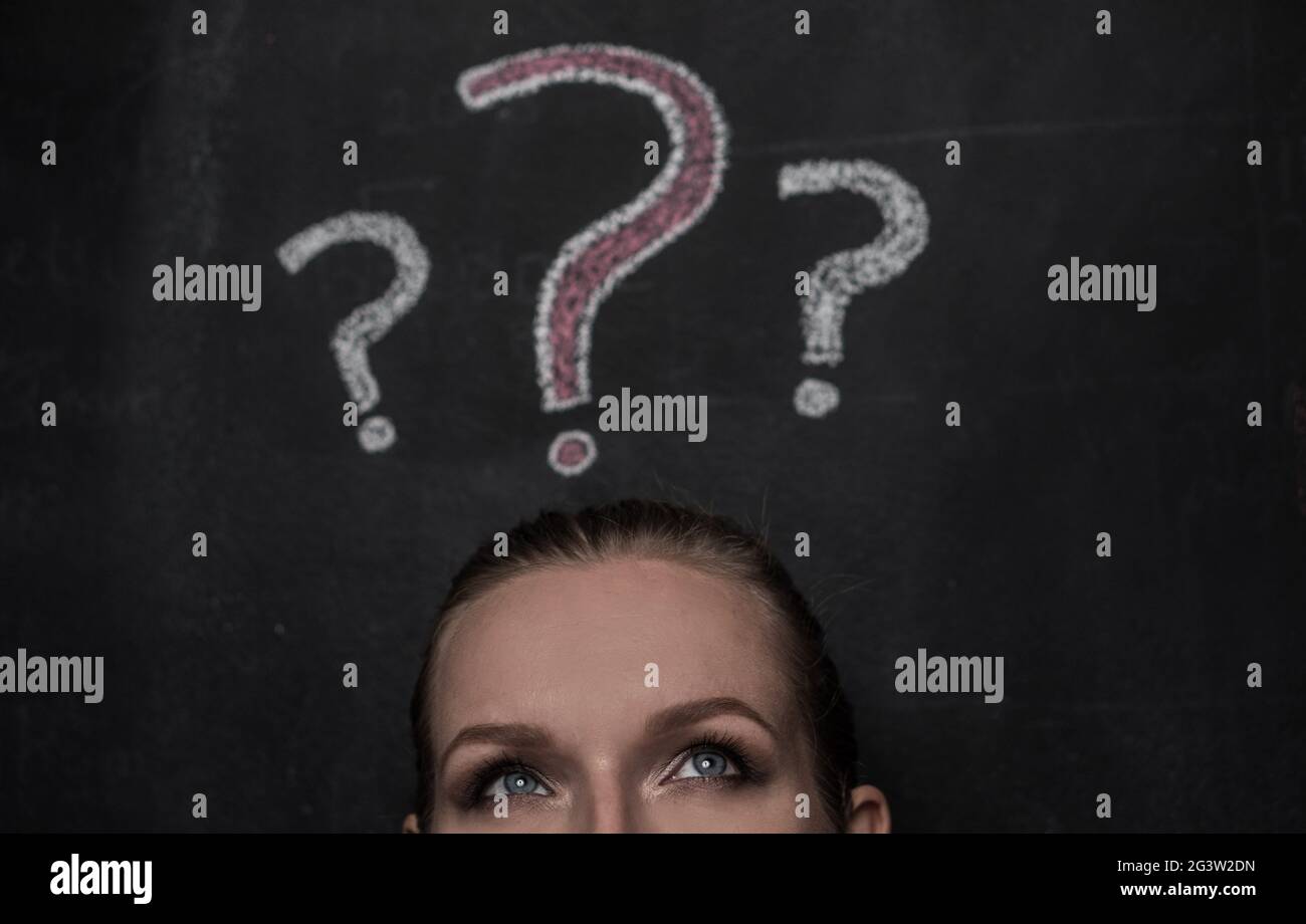 Confused woman and question marks Stock Photo - Alamy