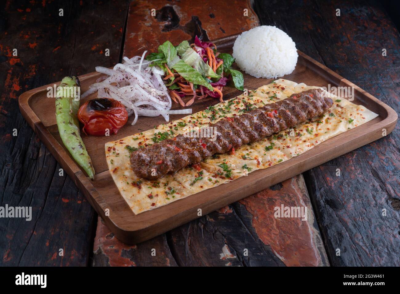 Turkish lula lamb or beef kebab with rice and vegetables on rustic ...