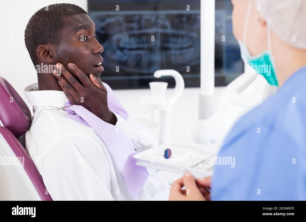 Professional positive doctor woman talking with patient in medical ...