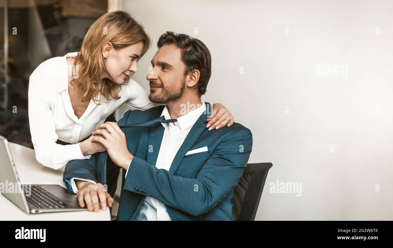 Flirting at work couple. Attractive Caucasian office workers man and ...
