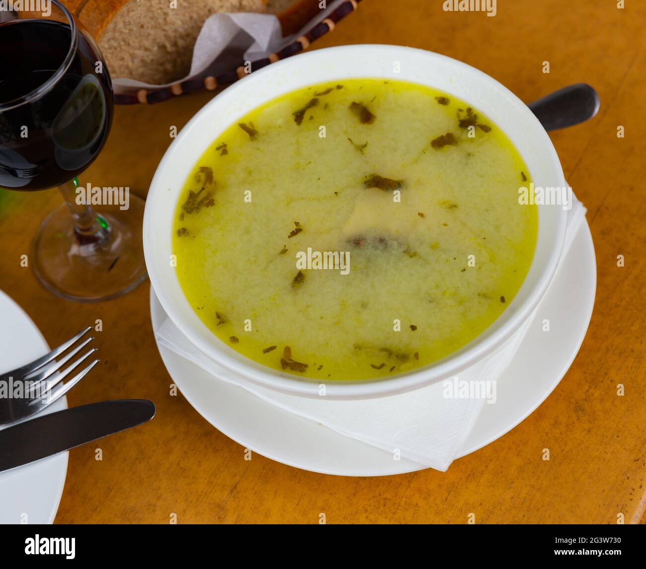 Georgian chicken soup Chikhirtma served with fresh bread Stock Photo ...