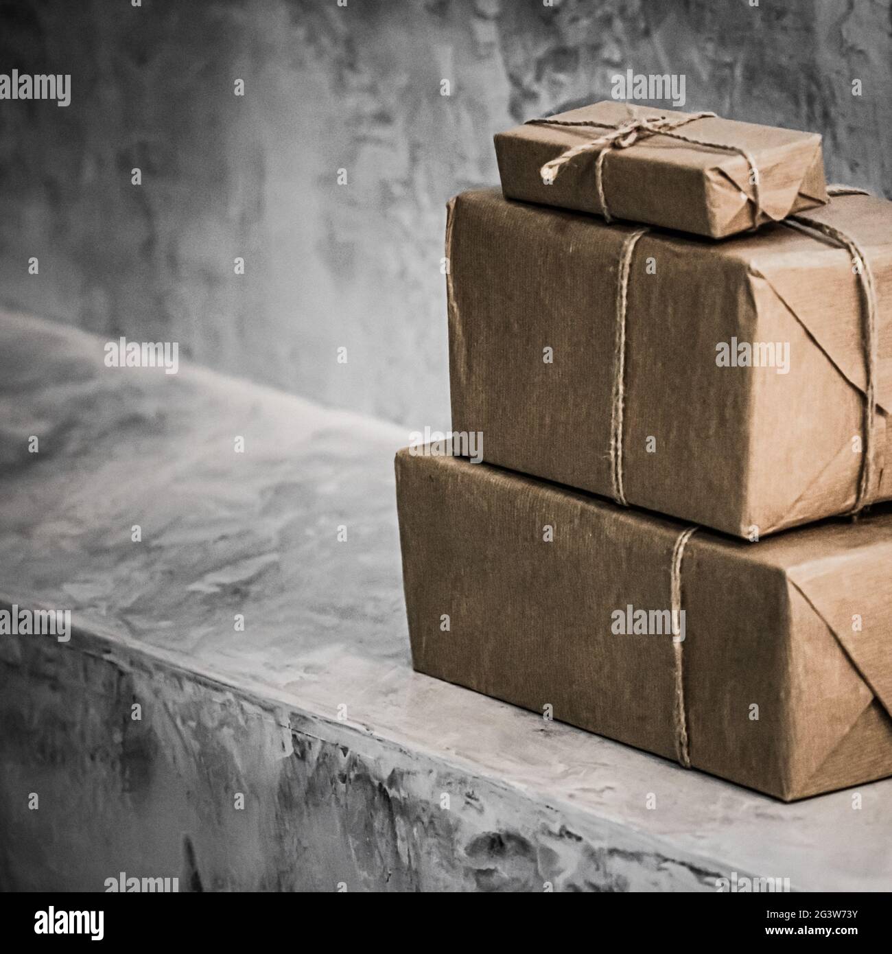 Parcels wrapped in brown paper in warehouse, packaged boxes for postal ...