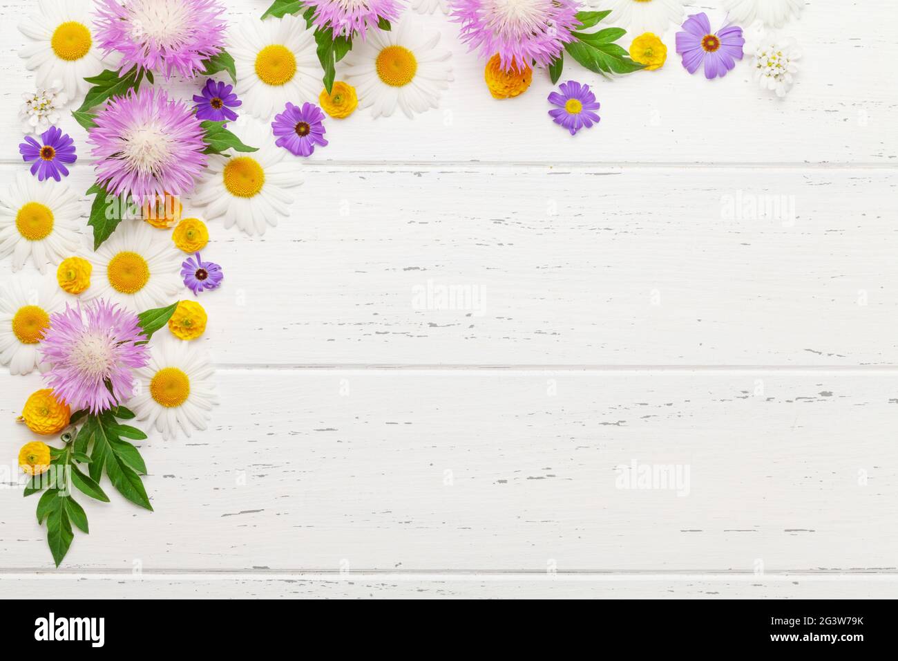 Various colorful garden flowers over wooden background. Greeting card ...