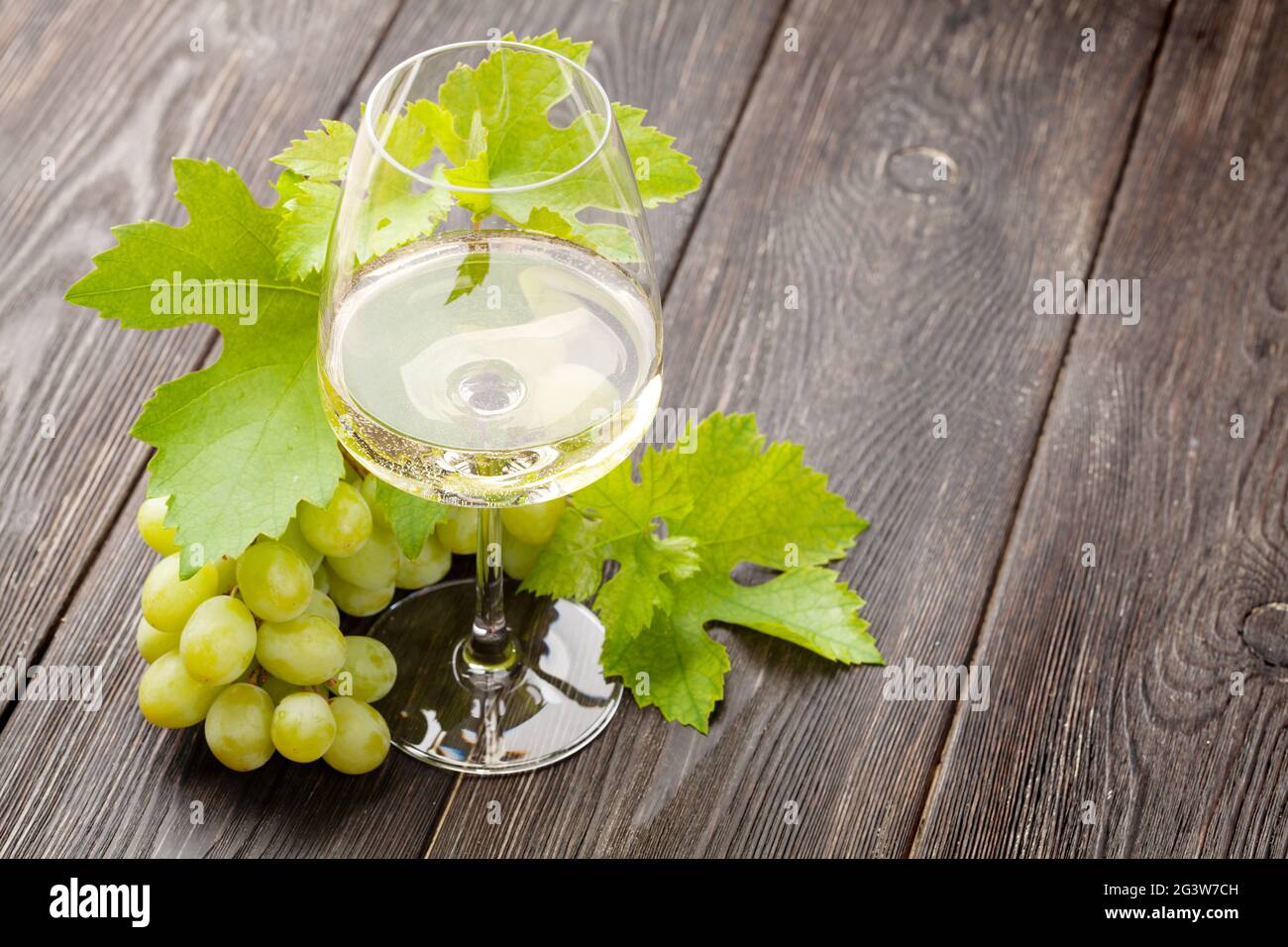 White wine glass and grape on old wooden table with copy space Stock ...