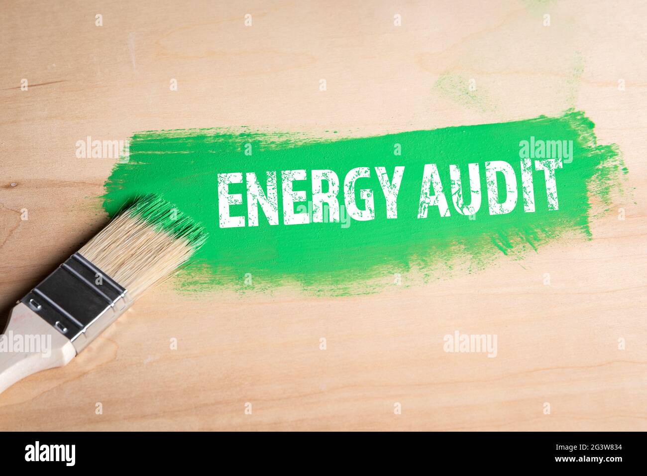 Energy Audit concept. Green color and a brush on a plywood background ...