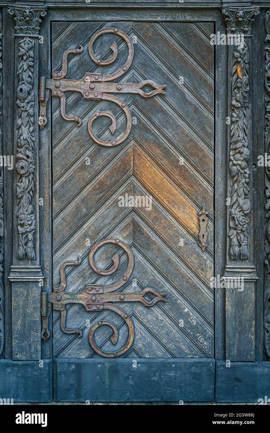 Vintage wooden door in baroque style with iron hinges Stock Photo - Alamy