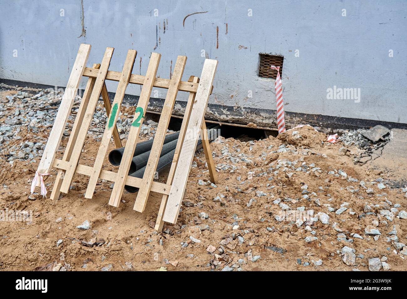 New plastic water pipes digging under old apartment building covered ...