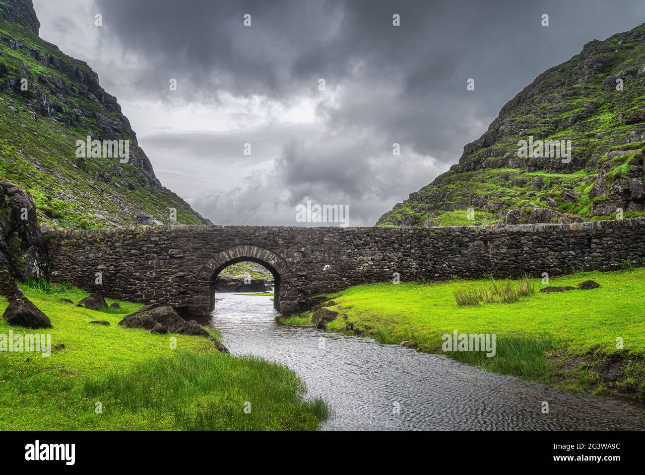 Small stone Wishing Bridge over winding stream in Gap of Dunloe Stock ...