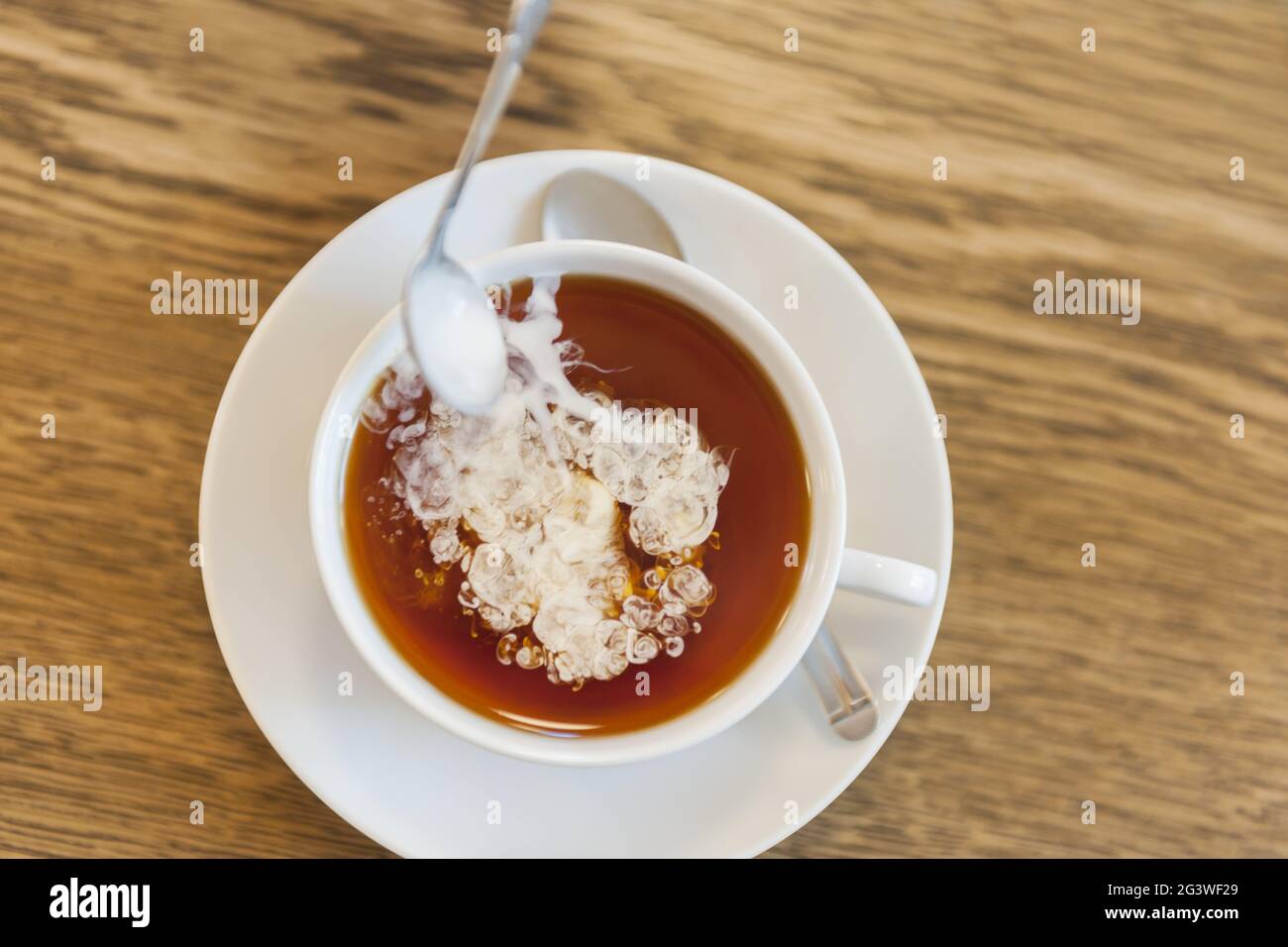 Tea with nice cream clouds from the spoon Stock Photo - Alamy