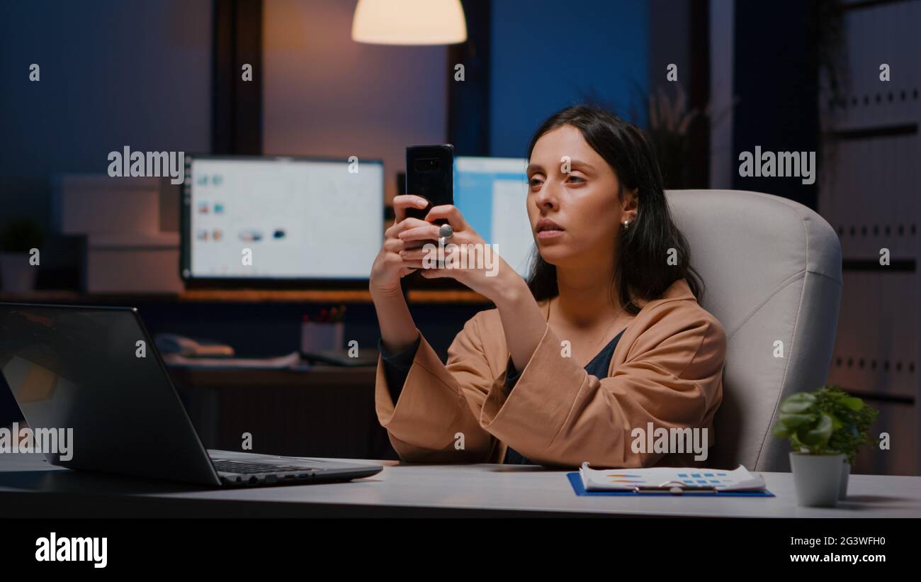 Executive browsing smartphone app night hi-res stock photography and ...