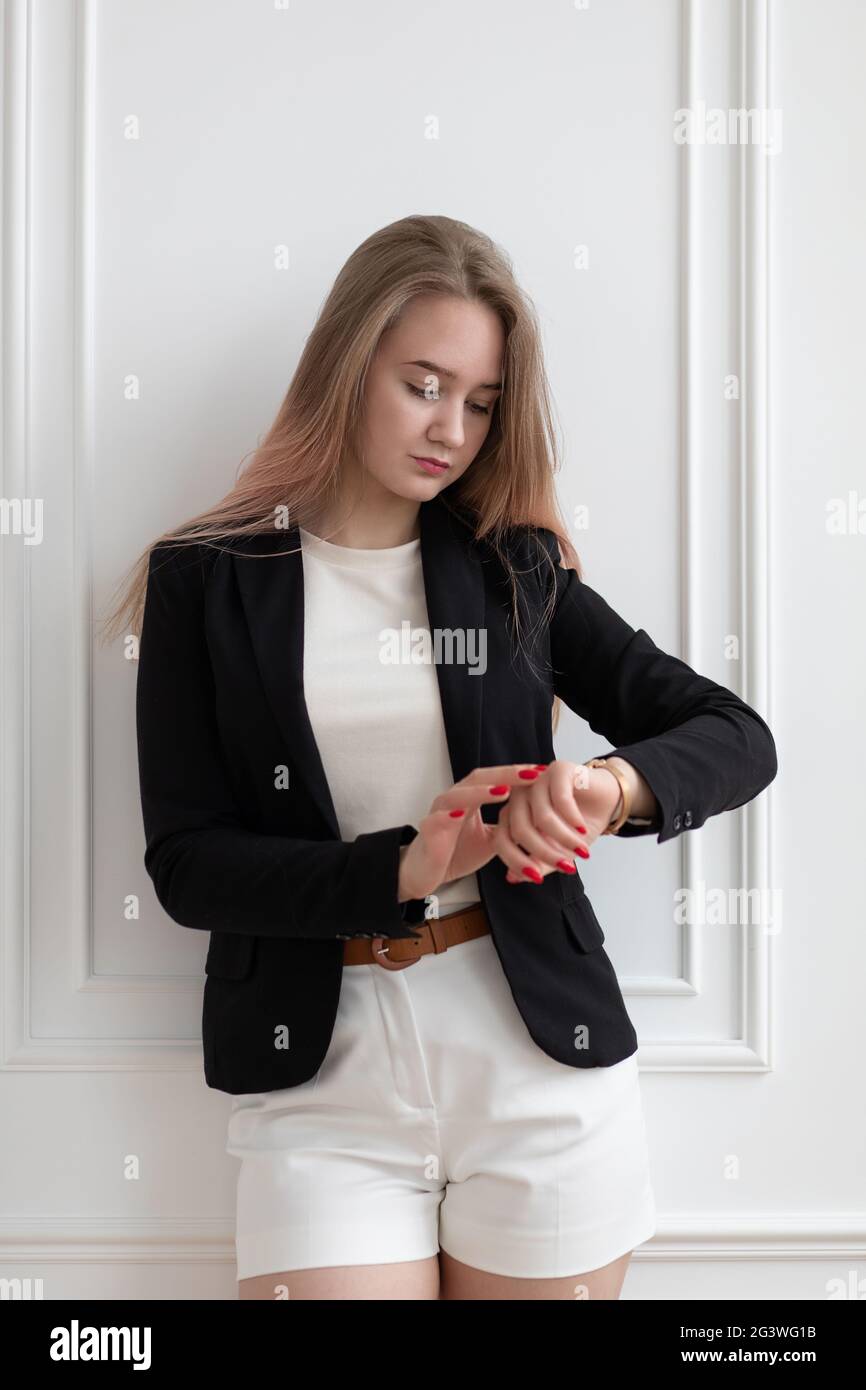 Woman checking clock office hi-res stock photography and images - Alamy