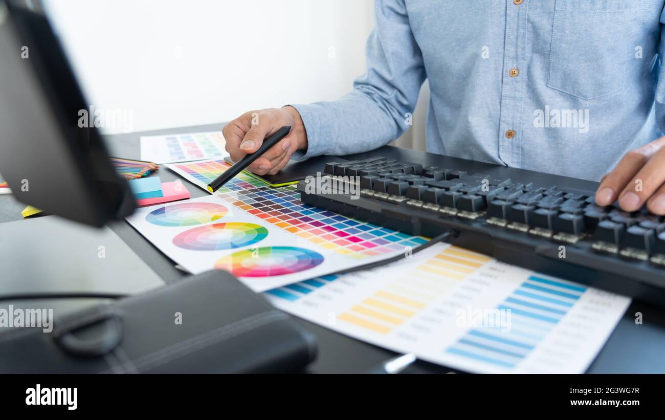 creative graphic designer choosing color scale for editing artwork ...