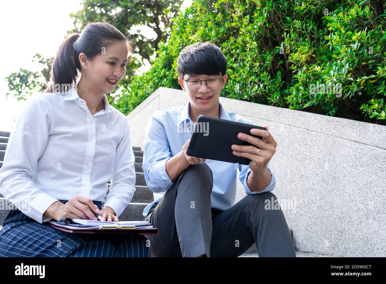 Business colleagues discussing work issues outdoor near the office ...