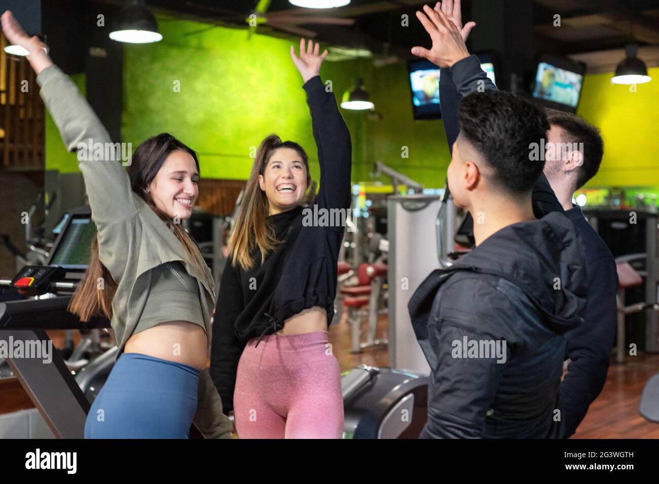 Happy diverse group of friends high five celebrating enjoying fitness ...