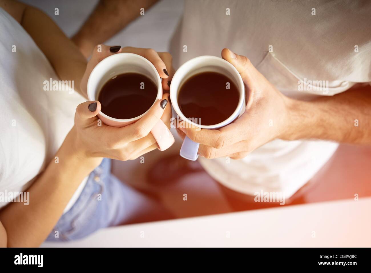 Woman holding mug two hands hi-res stock photography and images - Alamy