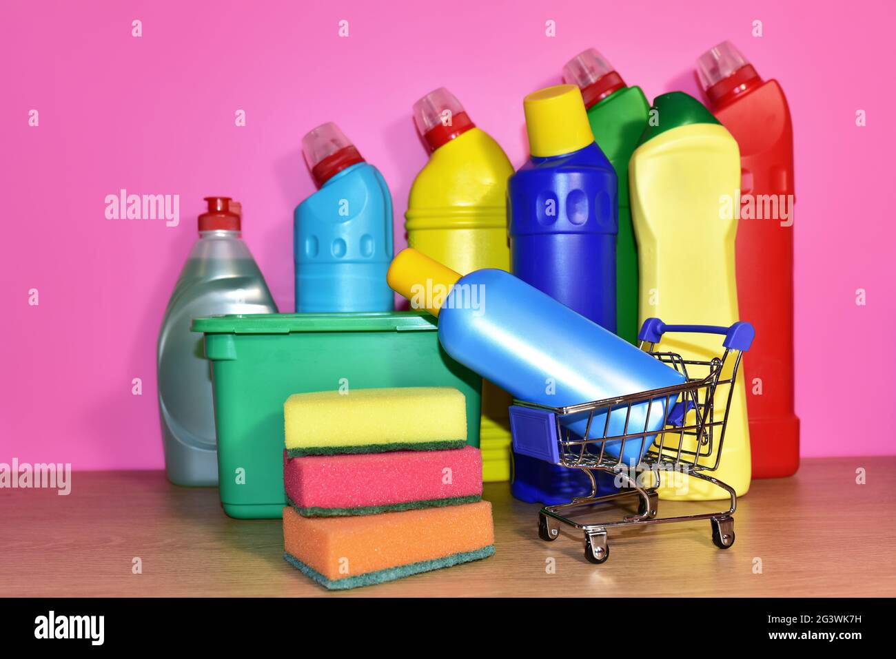 Detergent laundry bottles and sponge for washing on pink background ...