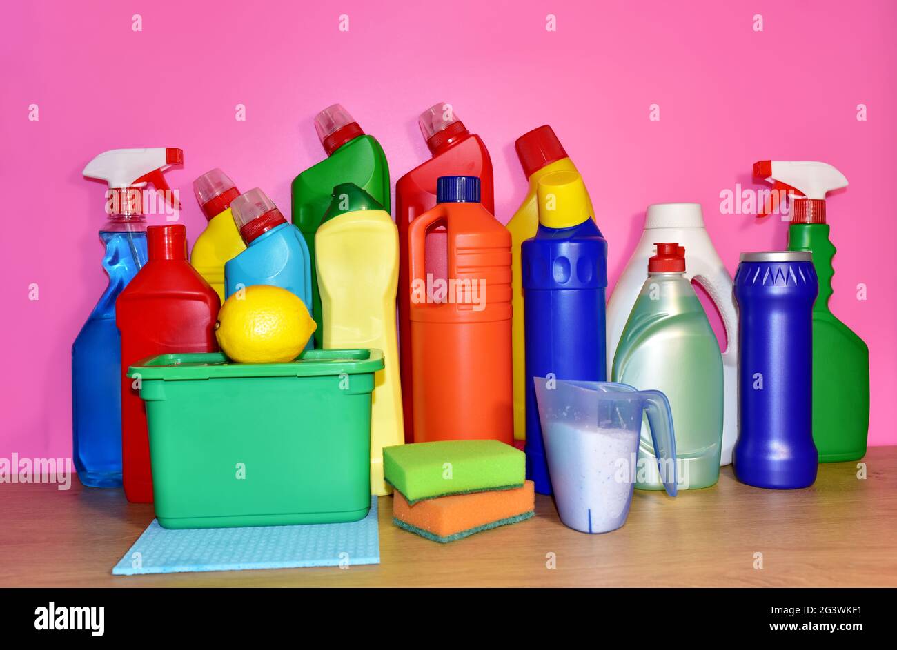 Detergent laundry bottles and sponge for washing on pink background ...