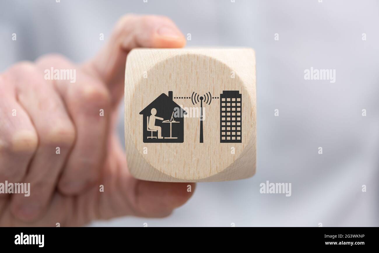 Hand holding a wooden cube with symbol of teleworking concept Stock ...