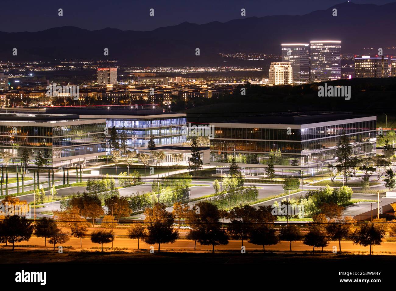 Twilight evening view of traffic streaming by the downtown skyline of ...